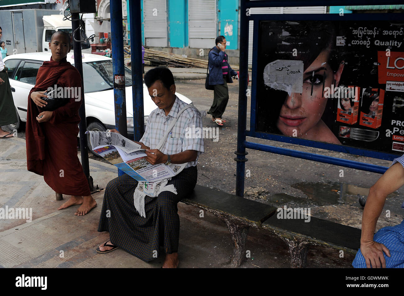 Reading newspaper bus stop hi-res stock photography and images - Alamy