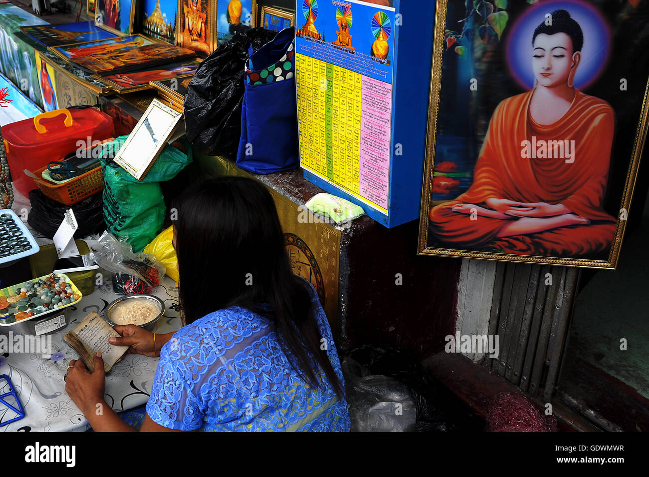 Reading woman and Buddha Stock Photo - Alamy