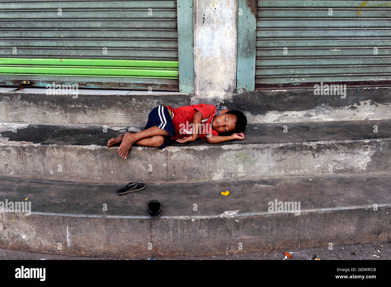 Homeless Child Sleeping On Street High Resolution Stock Photography and ...