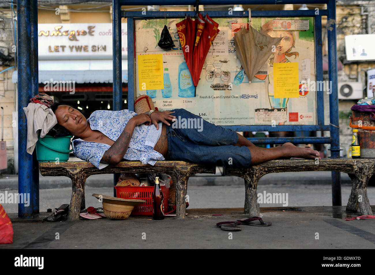 Homeless man sleeping bus stop hi-res stock photography and images - Alamy