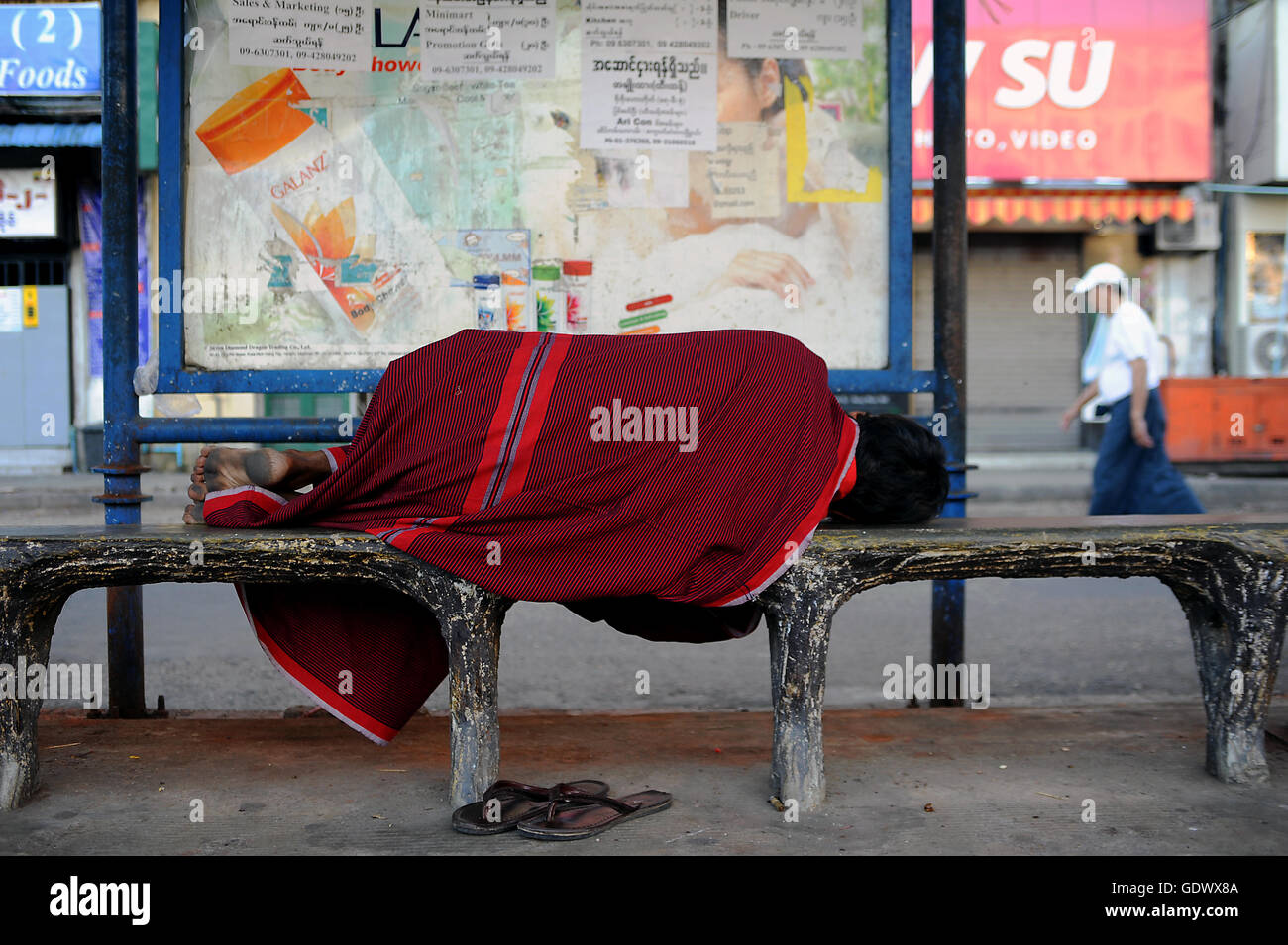 Homeless on bus stop bench hi-res stock photography and images - Alamy