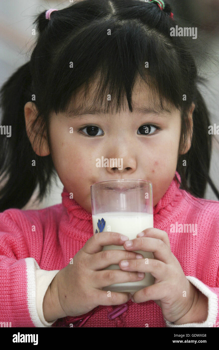 Girl drinks milk Stock Photo - Alamy