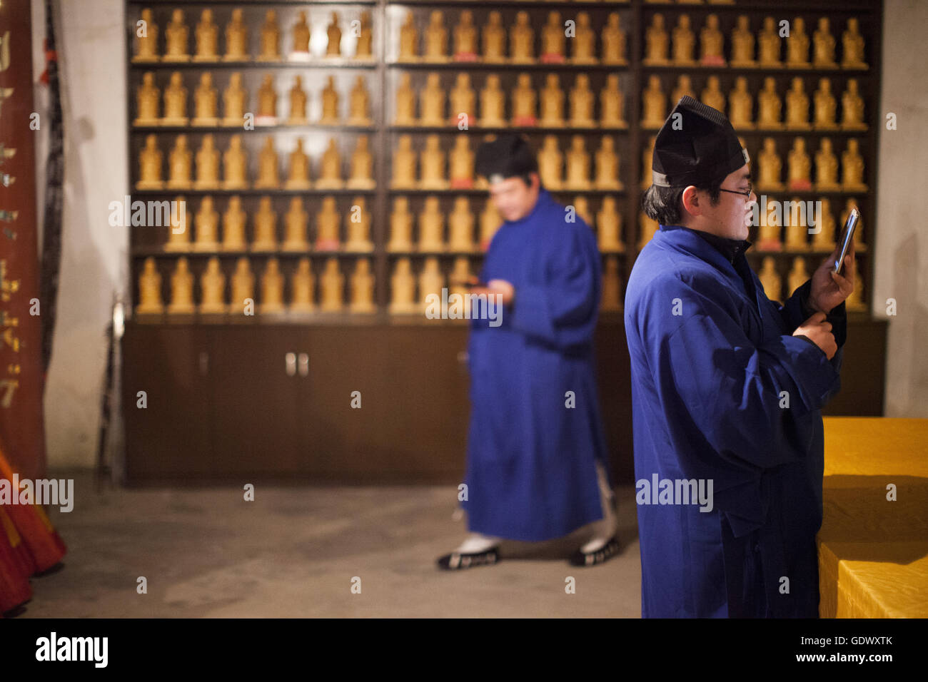 Daoist monks use cell phones at a Daoist temple Stock Photo - Alamy