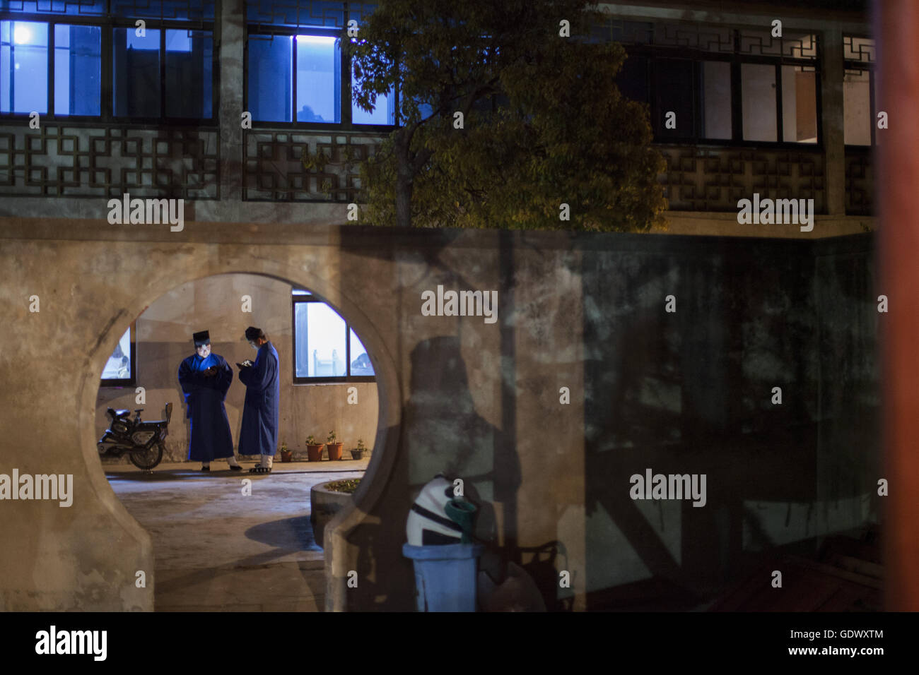Daoist monks use cell phones at a Daoist temple Stock Photo - Alamy