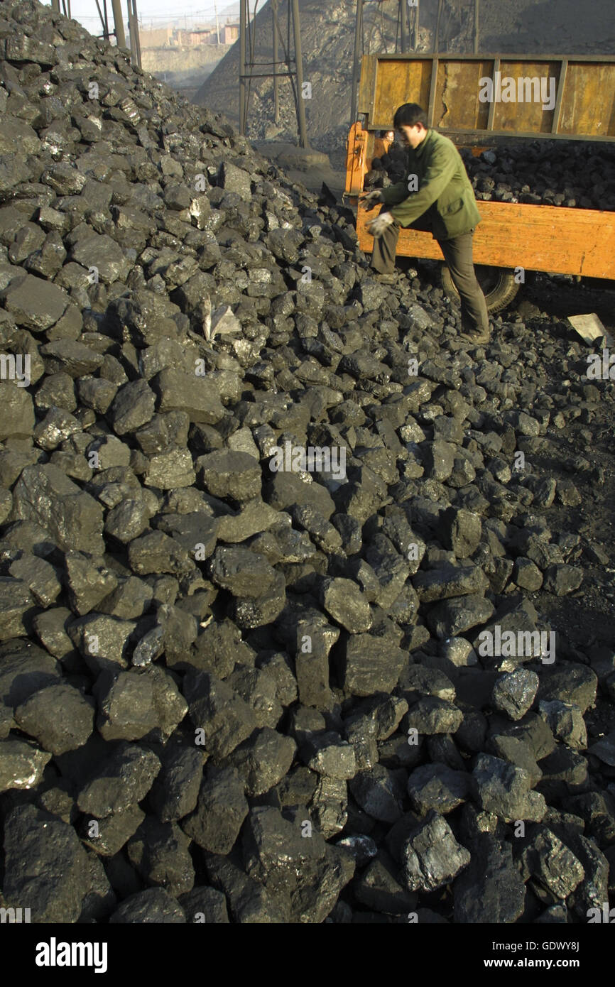 Workers sort coal bricks at a small coal mine Stock Photo - Alamy