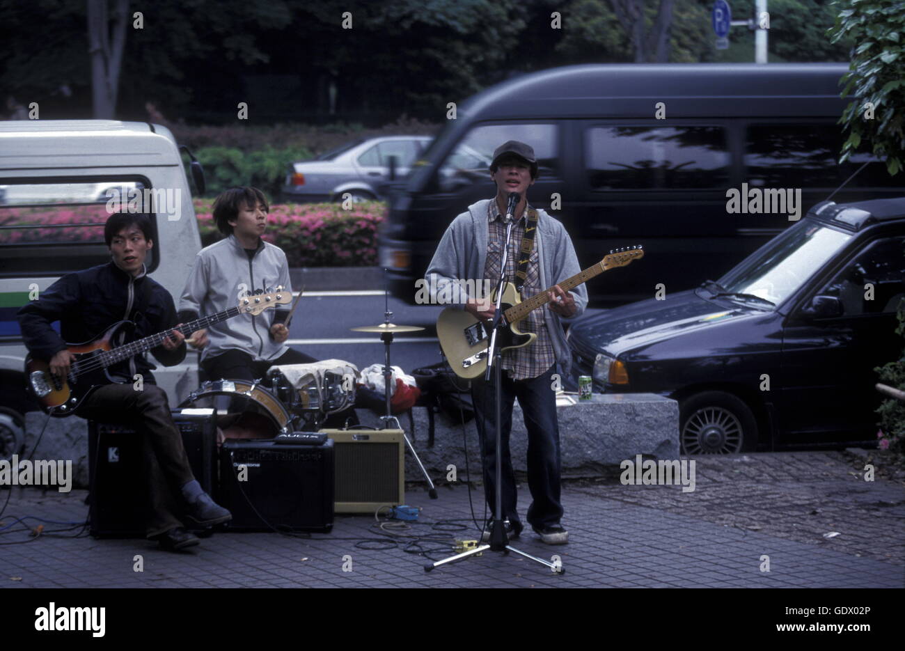a Japanese Youth Punk Band plays on a square in the City of Tokyo in ...