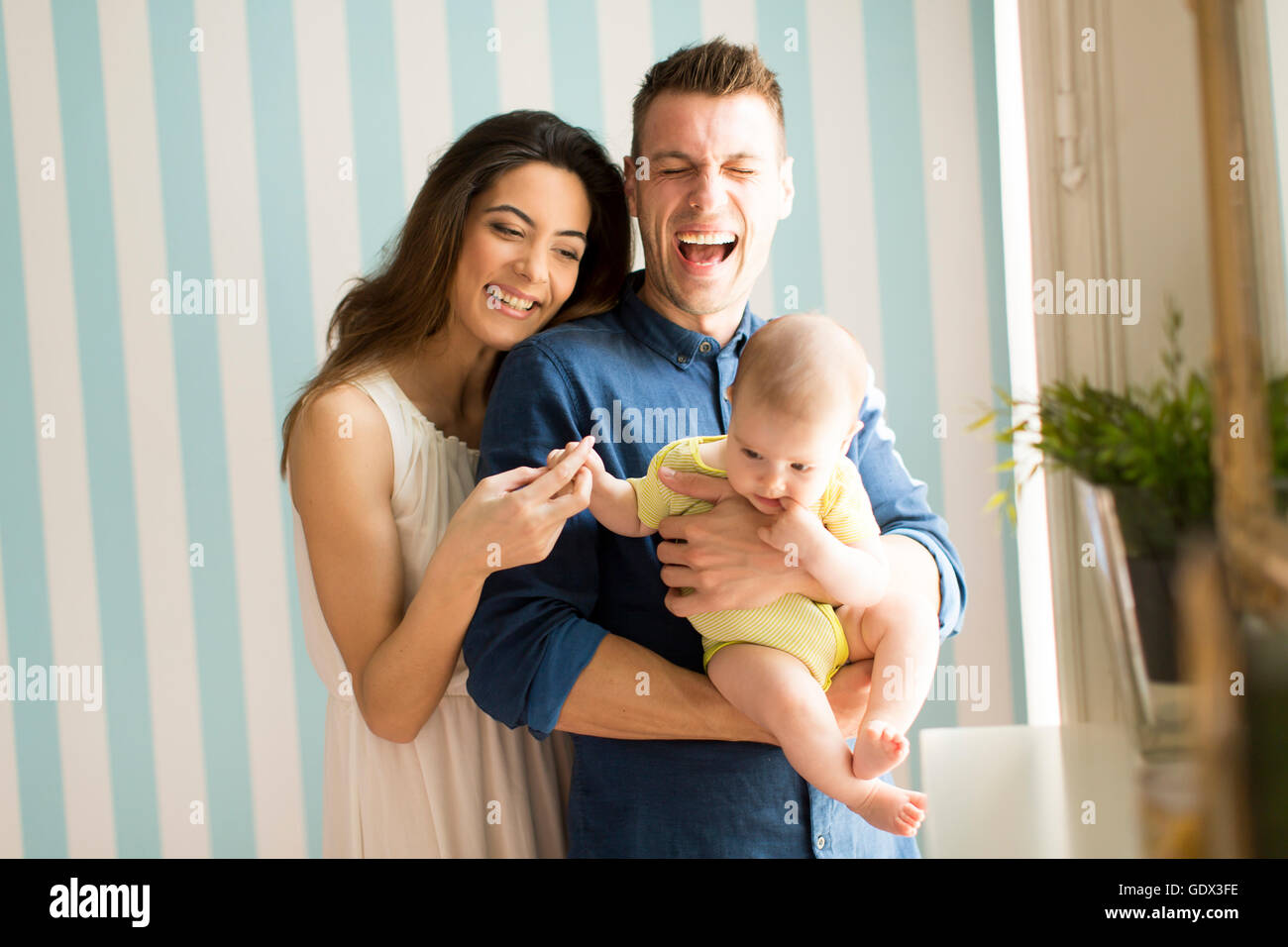 Happy young couple newborn baby family mother father hi-res stock ...