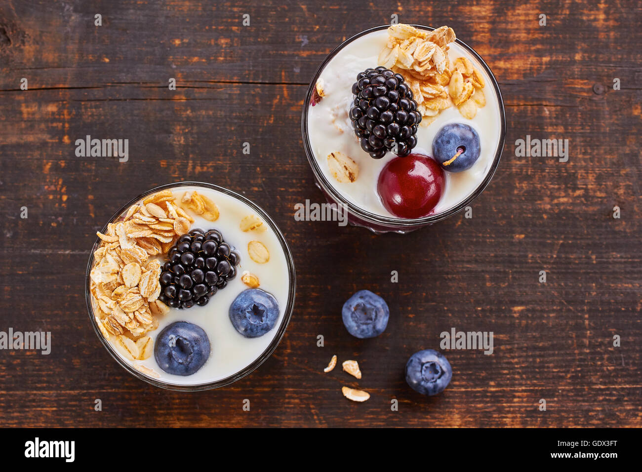 Two yogurt desserts with berries and muesli Stock Photo - Alamy
