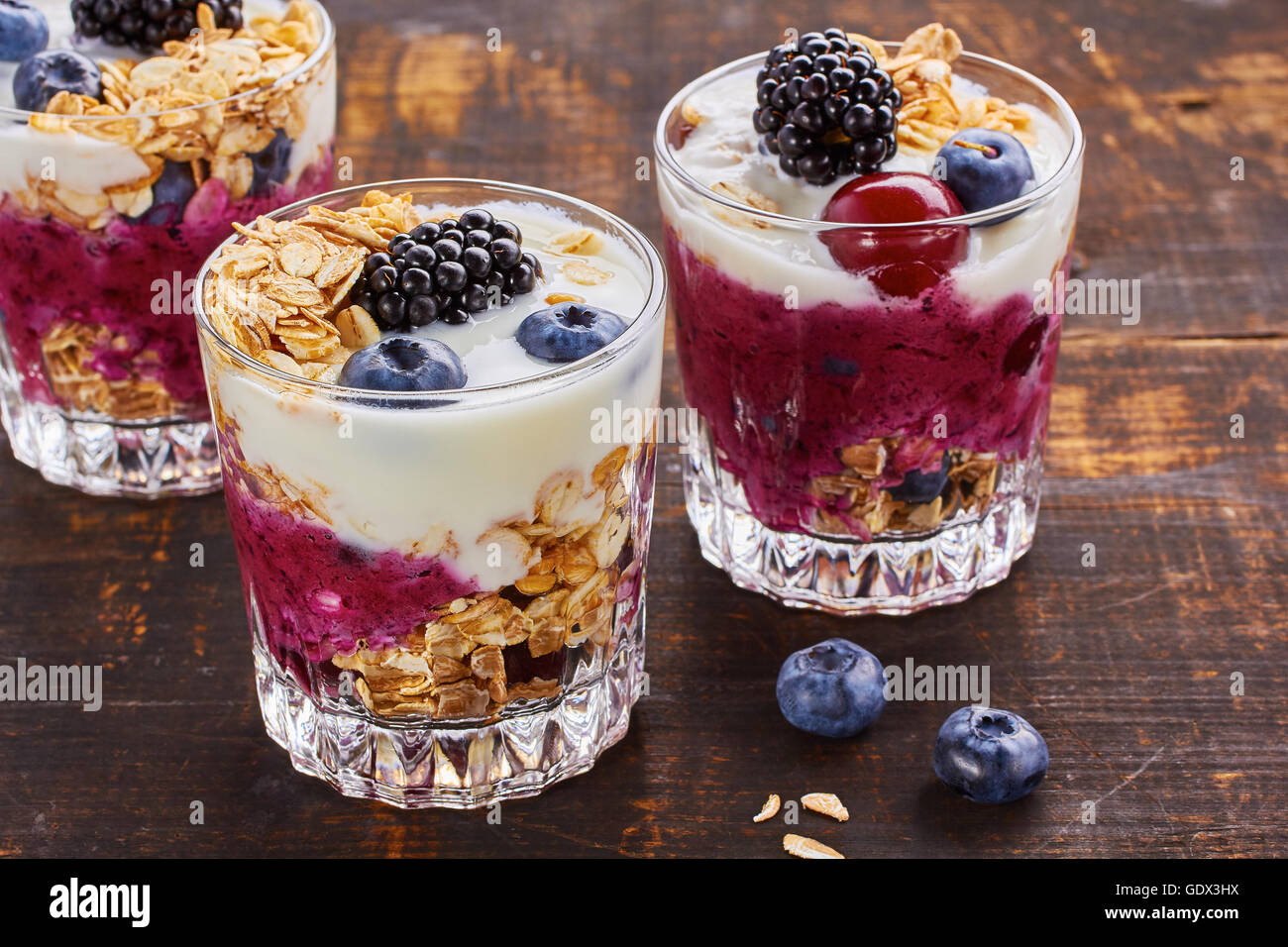 Tree yogurt desserts with berries and muesli Stock Photo - Alamy