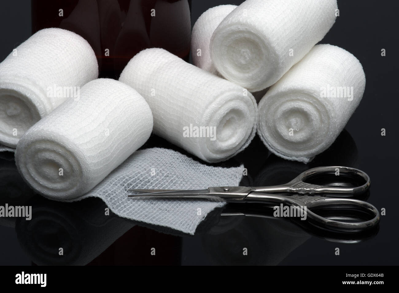 Medical bandage with scissors on black background Stock Photo - Alamy