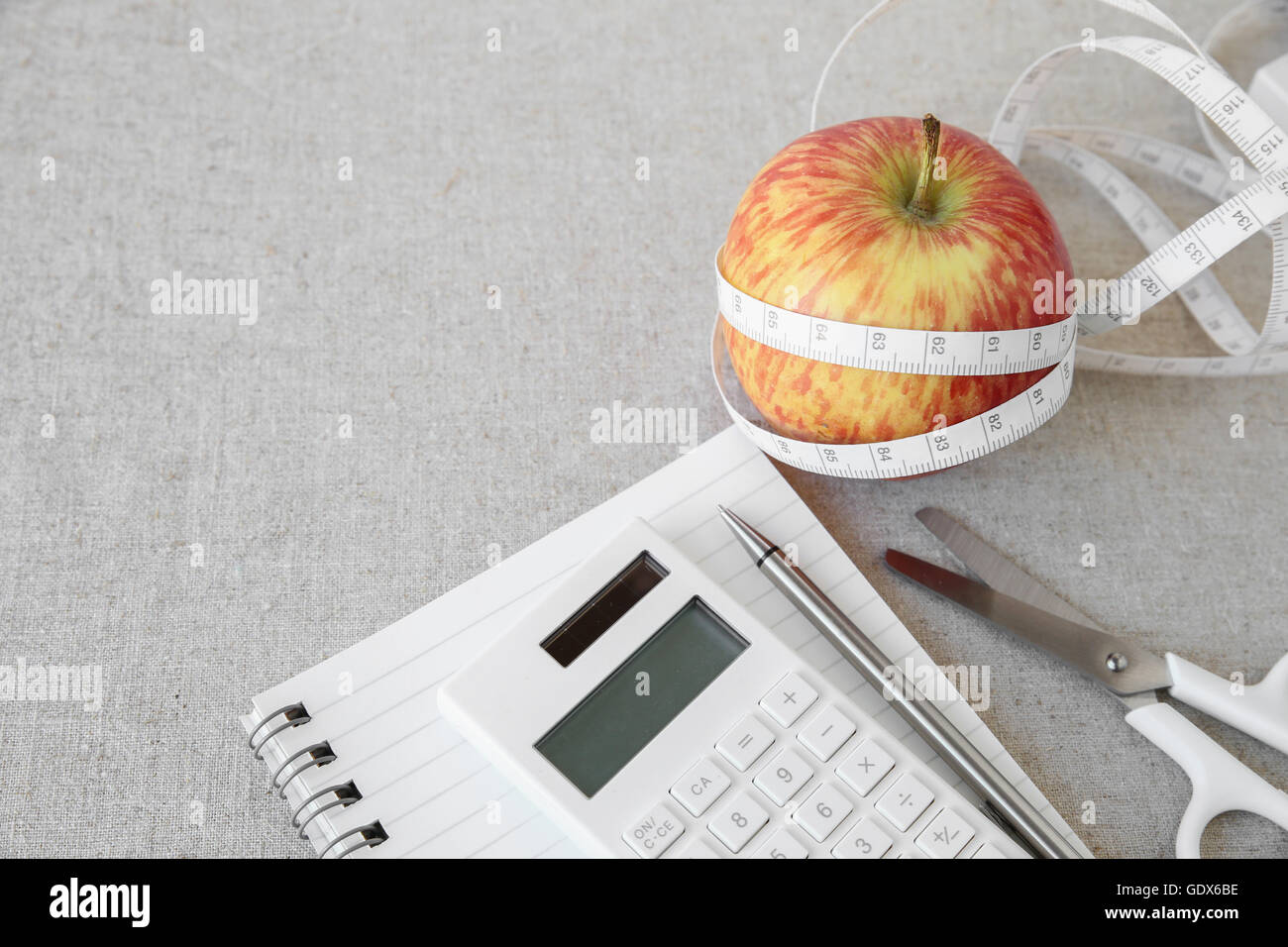 Apple, tape measure, notebook and calculator background for diet plan ...