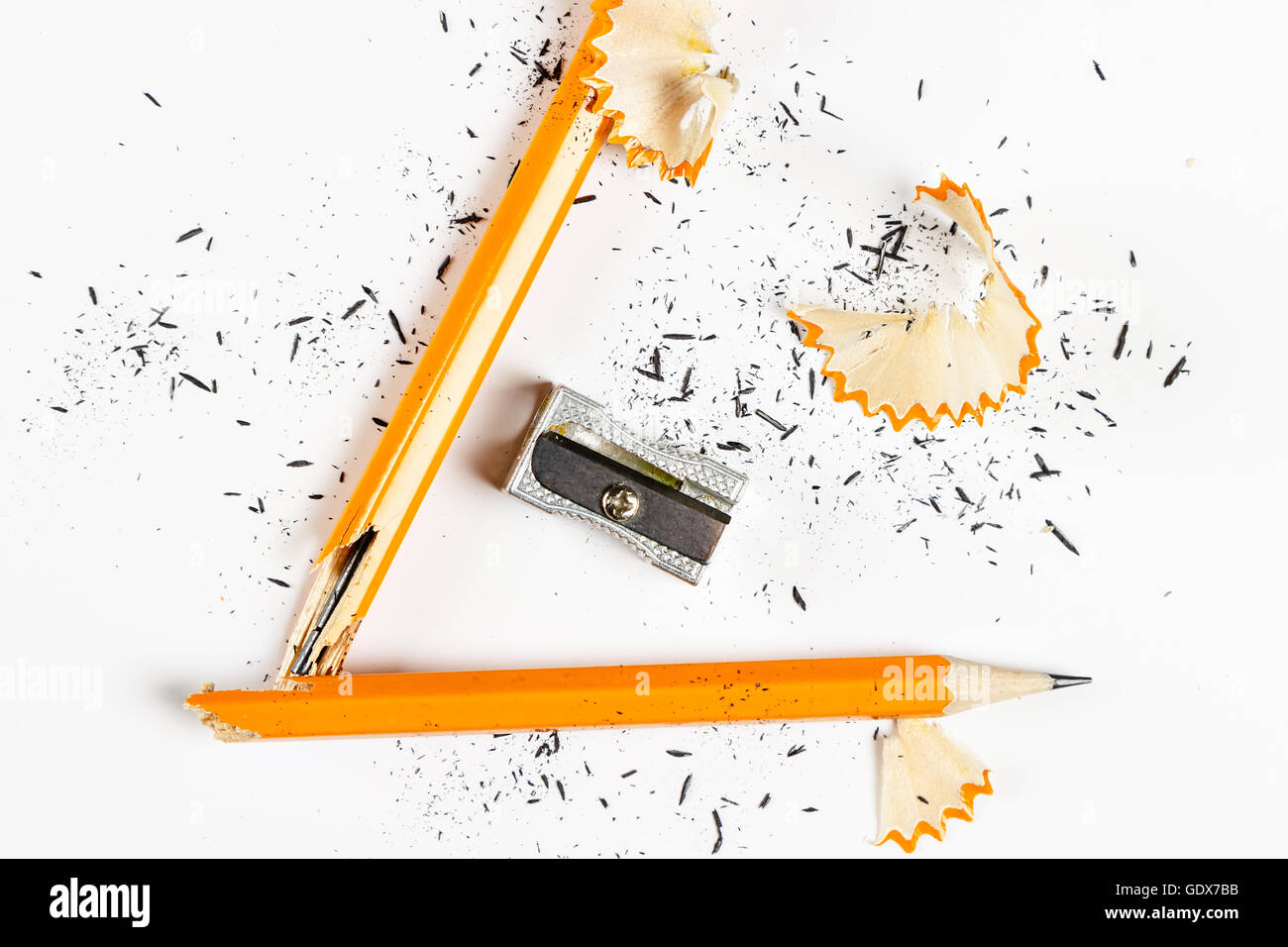Pencil, metal sharpener and pencil shavings on white background ...