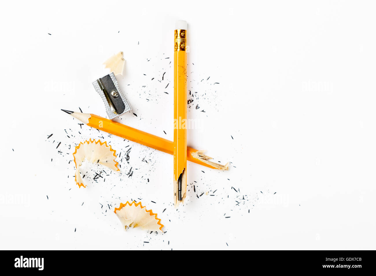 Pencil, metal sharpener and pencil shavings on white background ...