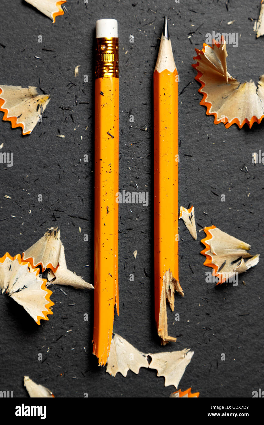 Broken pencil with shavings on black background. Vertical image Stock ...