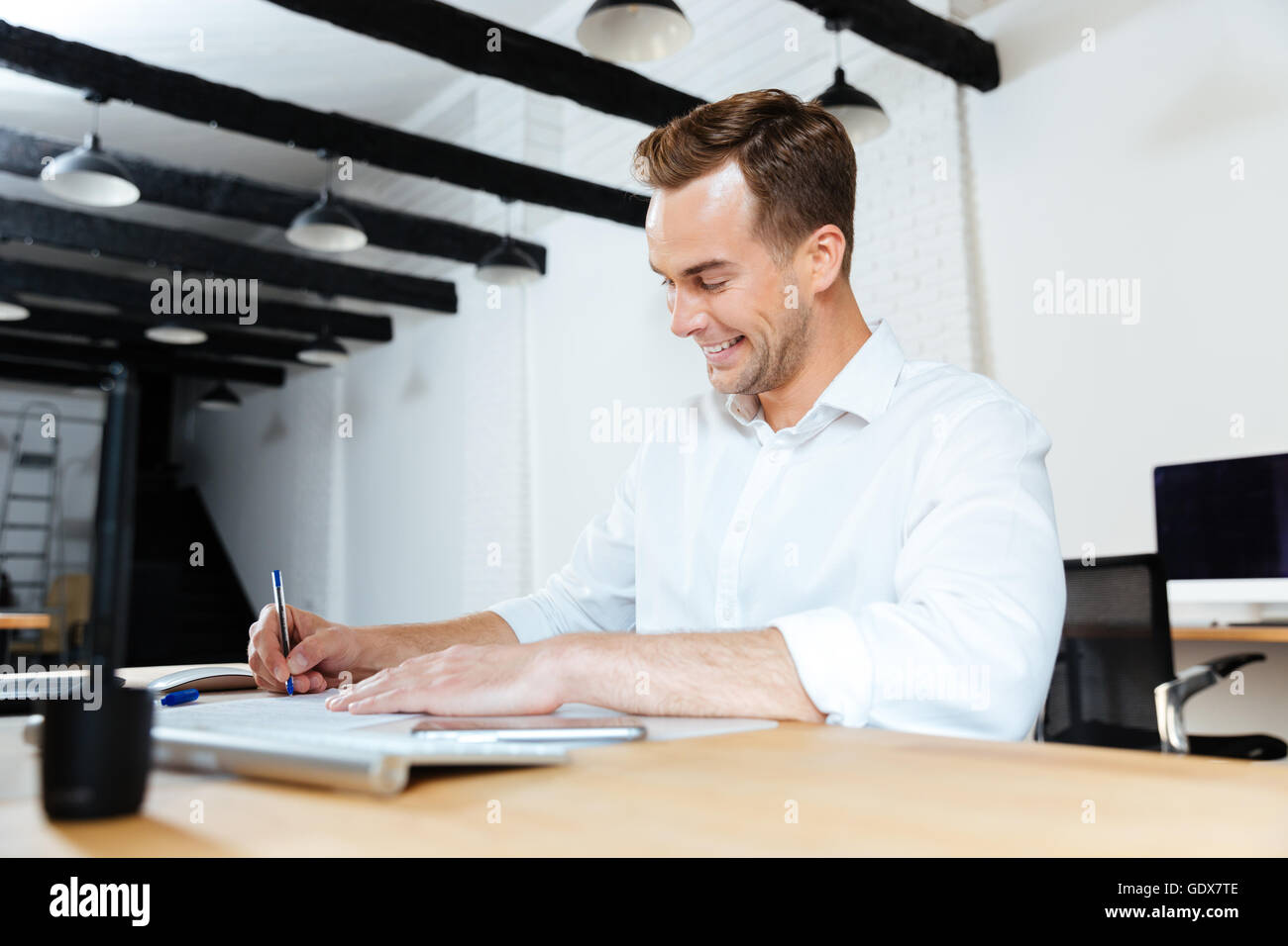 Man sitting at table alone writing hi-res stock photography and images ...