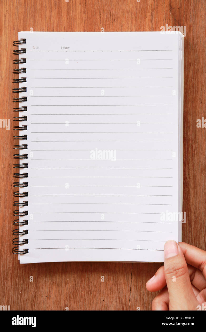 Handle notepad with a spiral binding on wood table Stock Photo - Alamy