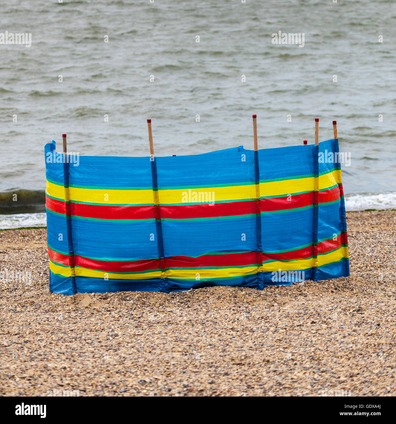 Colourful Windbreak on Beach Stock Photo - Alamy
