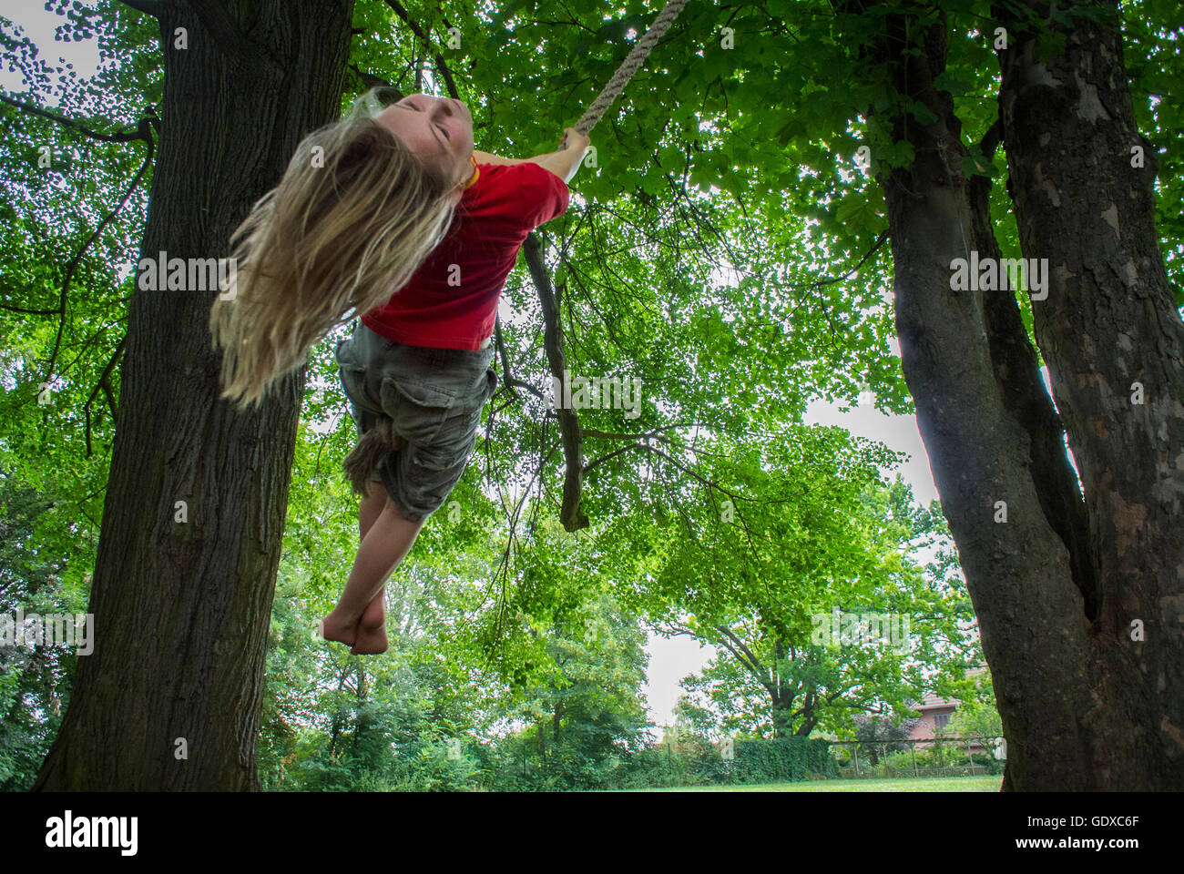 Swinging on a rope swing hi-res stock photography and images - Alamy