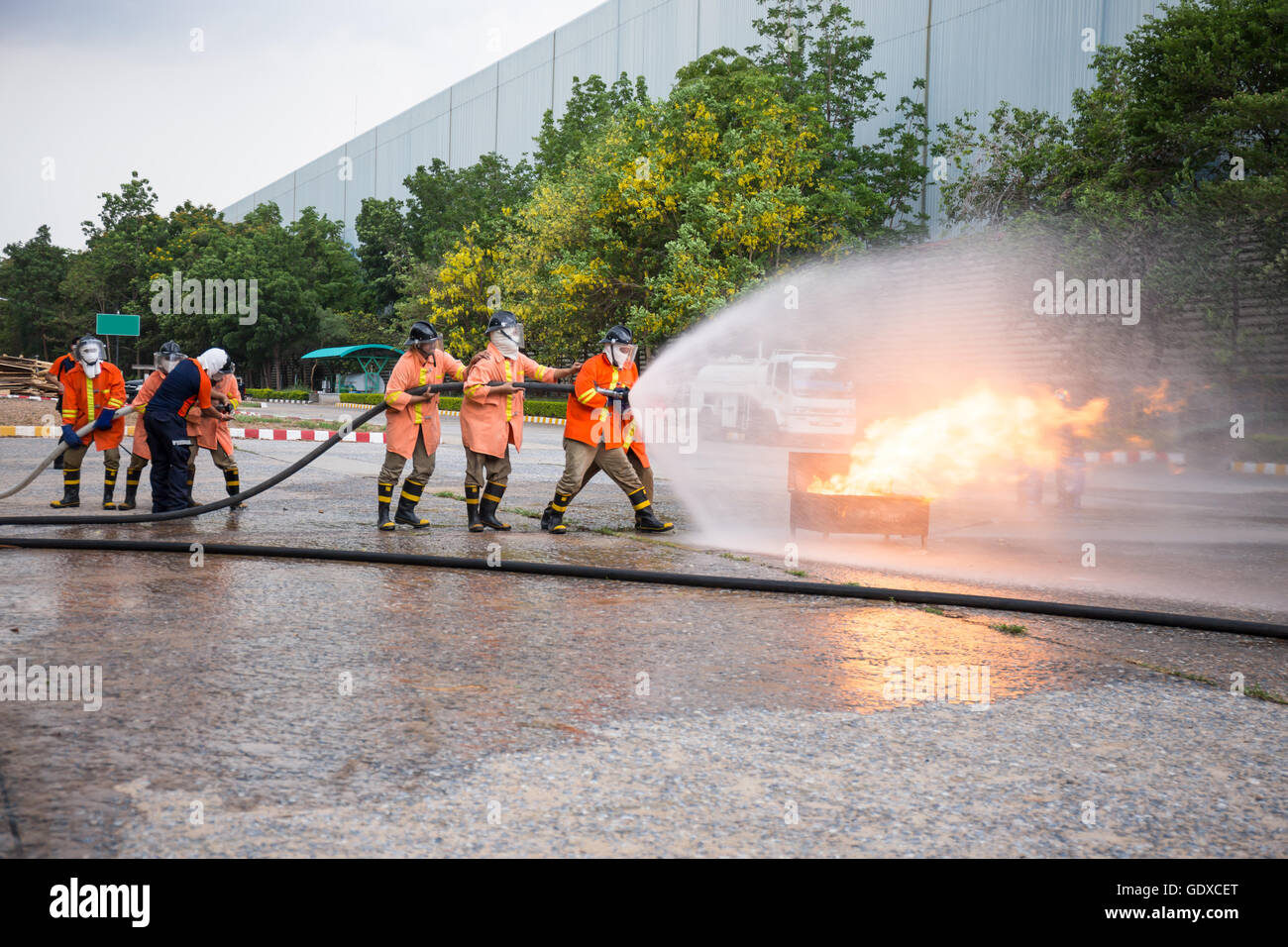 Firefighters attack fire during a training exercise Stock Photo - Alamy