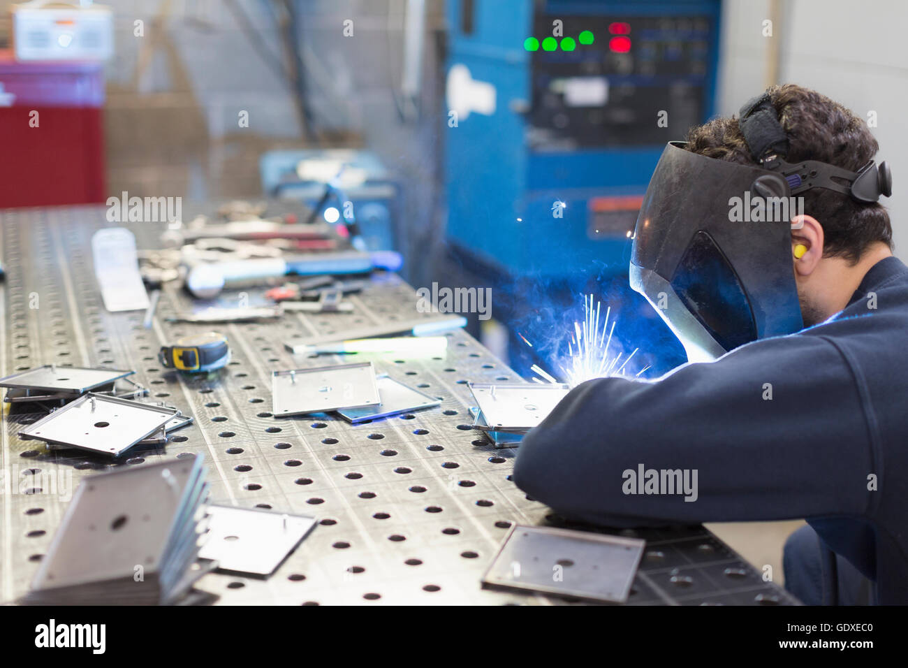 Welder welding pieces in steel factory Stock Photo - Alamy