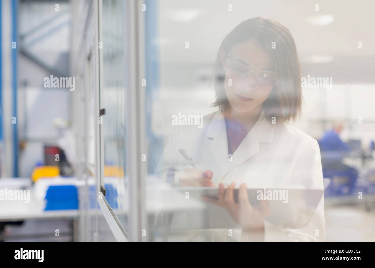 Engineer taking notes on clipboard in steel factory office Stock Photo ...