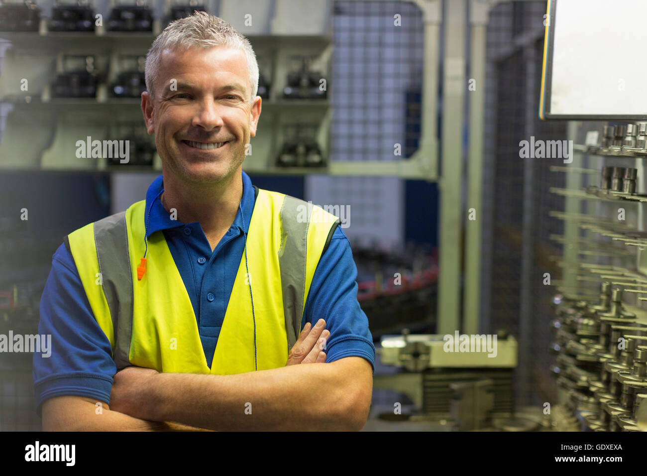 Portrait smiling worker in steel factory Stock Photo - Alamy
