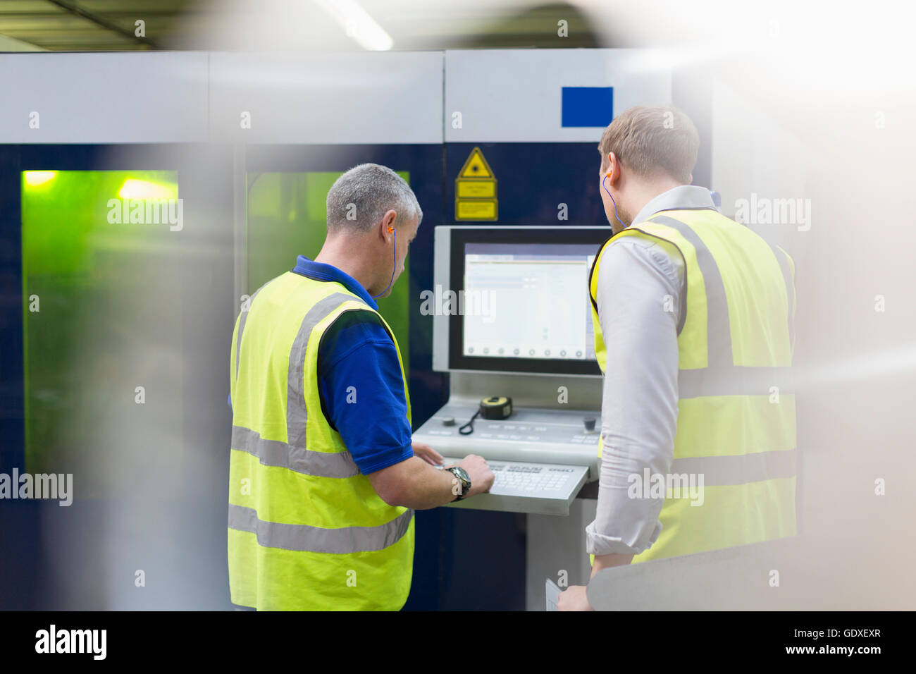Workers at machinery control panel in steel factory Stock Photo - Alamy
