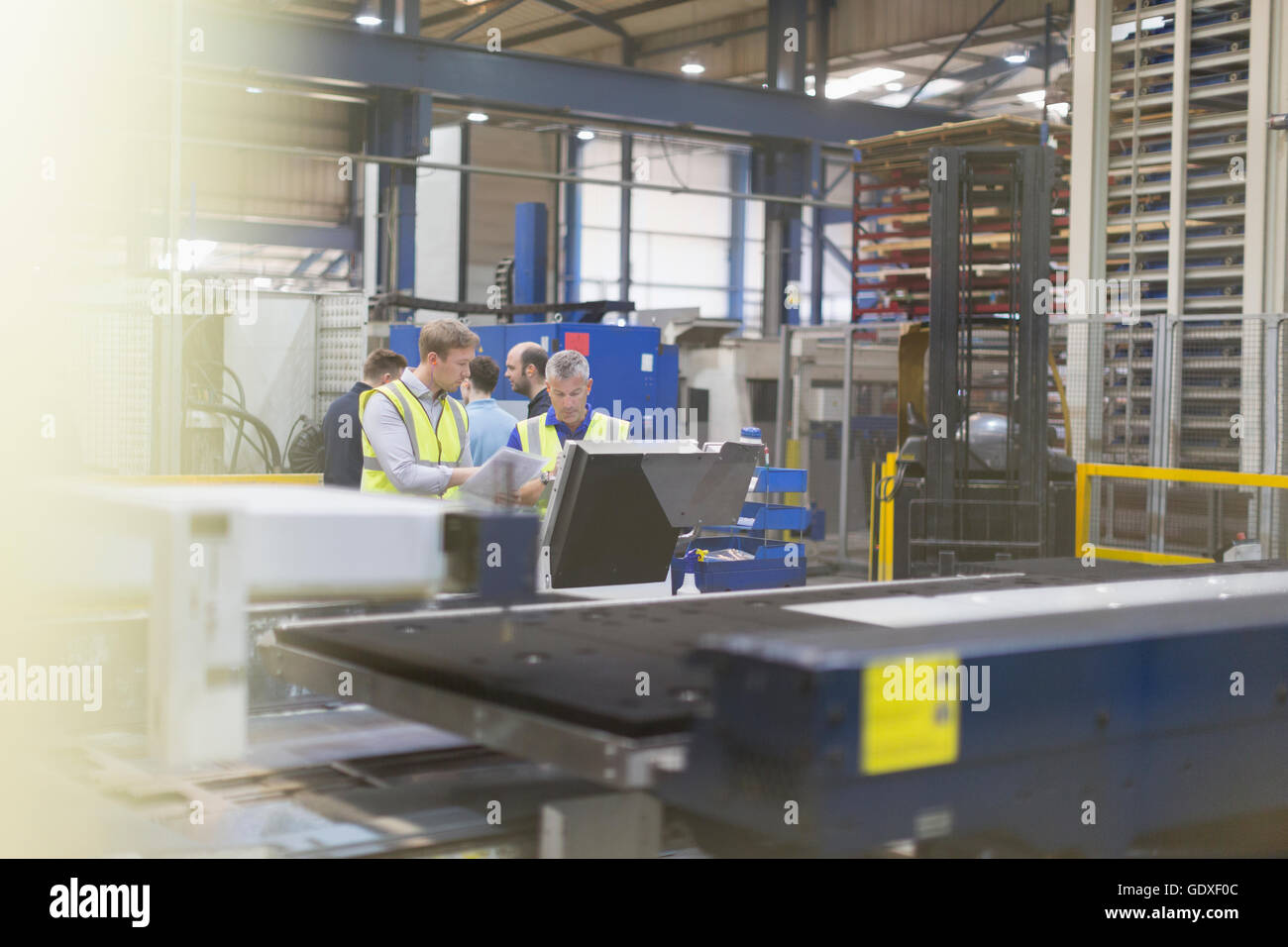 Supervisor and workers in steel factory Stock Photo - Alamy