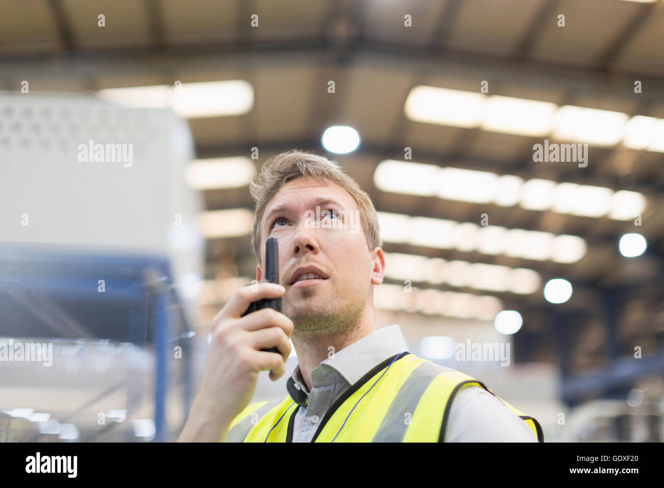 Supervisor using walkie-talkie in steel factory Stock Photo - Alamy