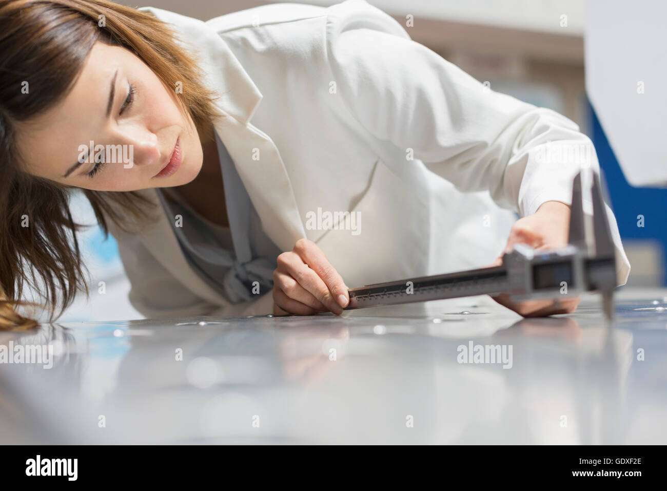 Engineer with calipers measuring sheet metal in steel factory Stock ...