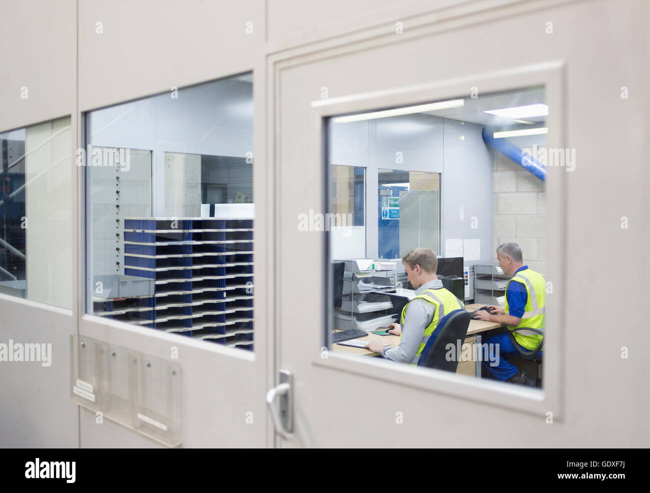 Workers working at computers in steel factory office Stock Photo - Alamy