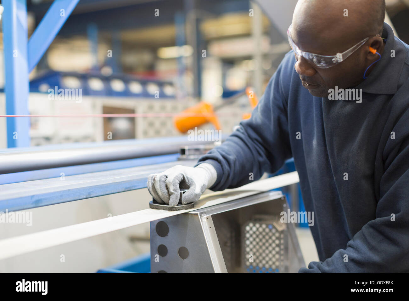 Worker sanding steel in steel factory Stock Photo - Alamy
