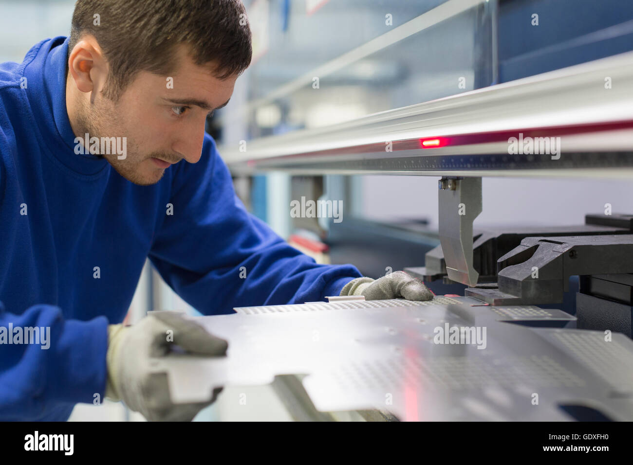 Worker operating laser cutter in steel factory Stock Photo - Alamy