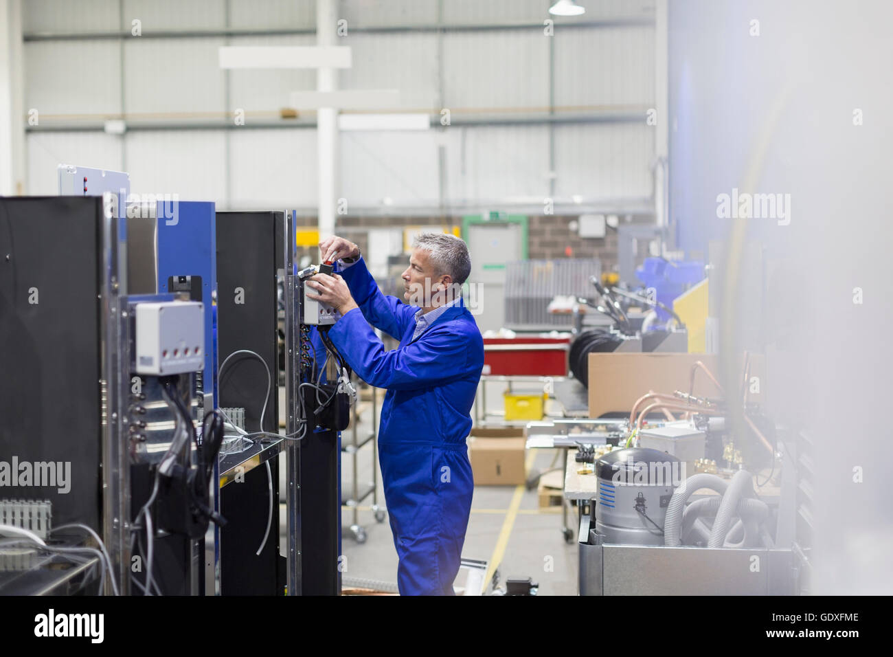 Worker repairing machinery in steel factory Stock Photo - Alamy