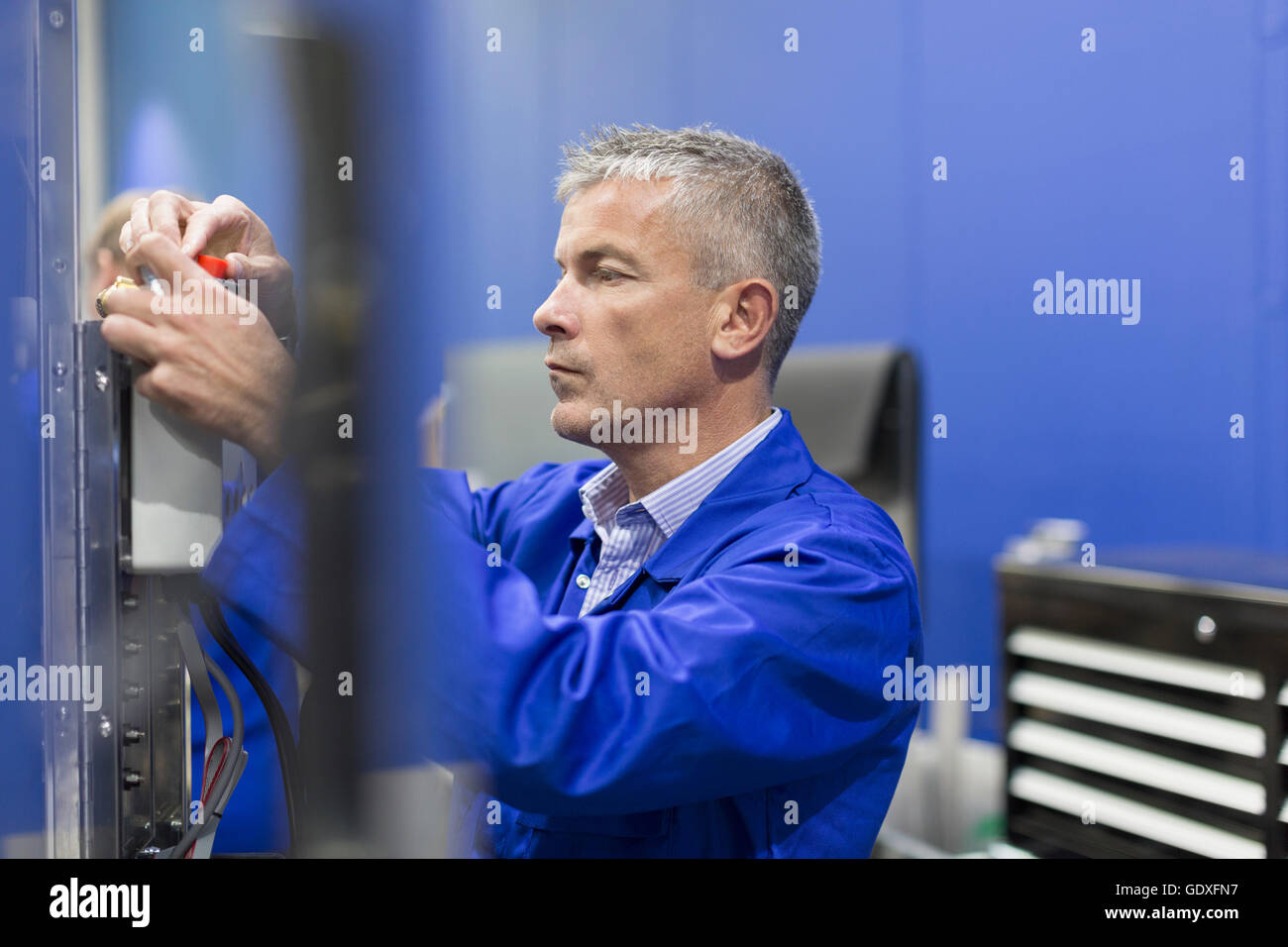 Worker adjusting machinery in hi-res stock photography and images - Alamy