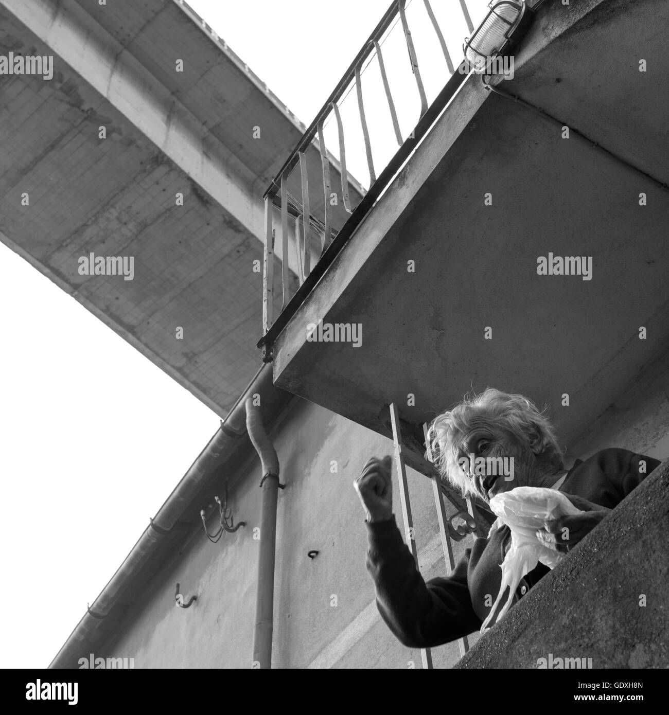 Portrait of an elderly woman in her home under a highway bridge in ...