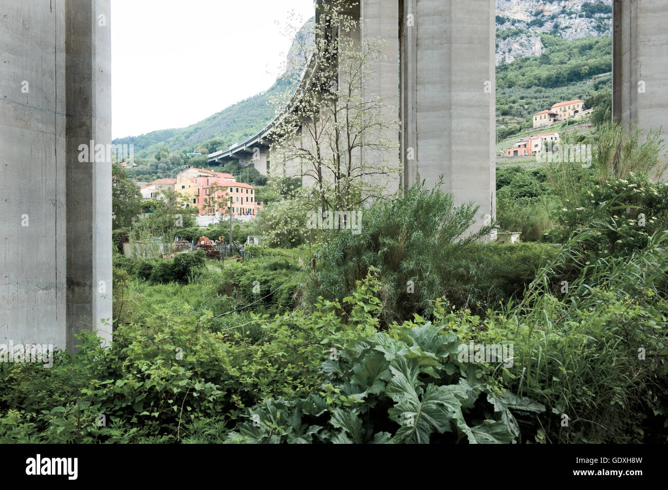 Town under a highway bridge in Liguria, Italy, 2012 Stock Photo - Alamy