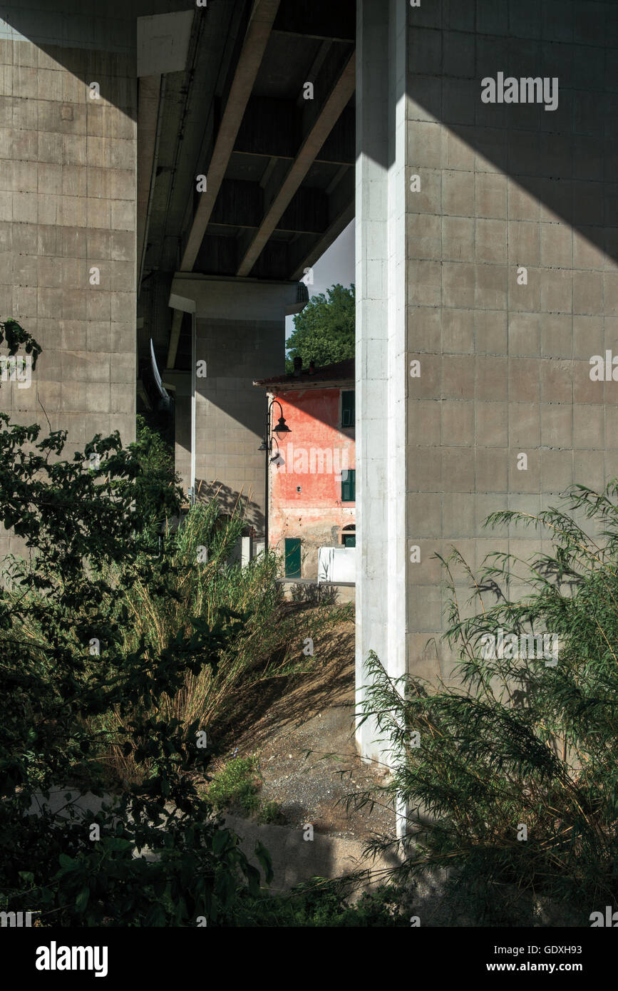 Housing under a highway bridge in Liguria, Italy, 2012 Stock Photo - Alamy