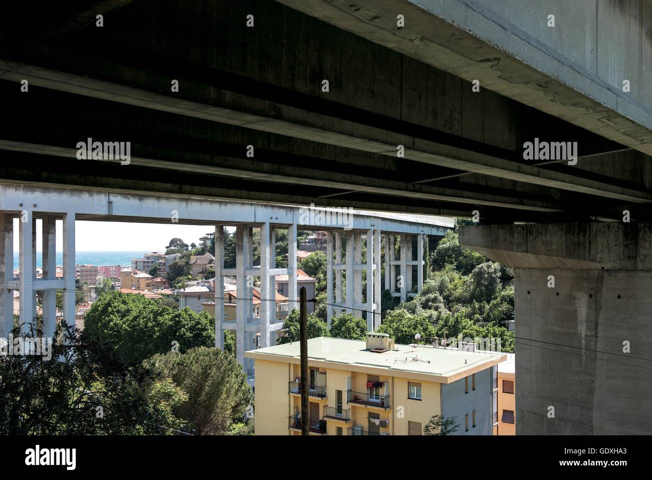 Town in the mountains under a highway bridge in Liguria, Italy, 2012 ...
