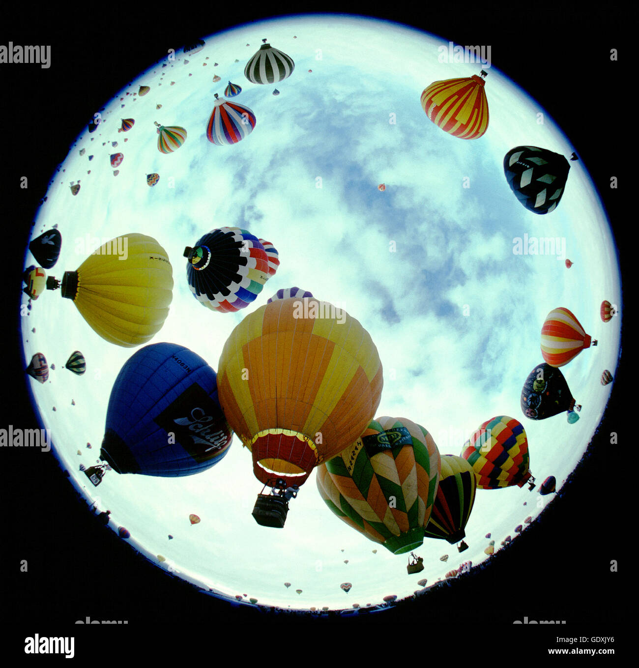 A mass ascension of hot air balloons captured with a fish-eye lens at ...
