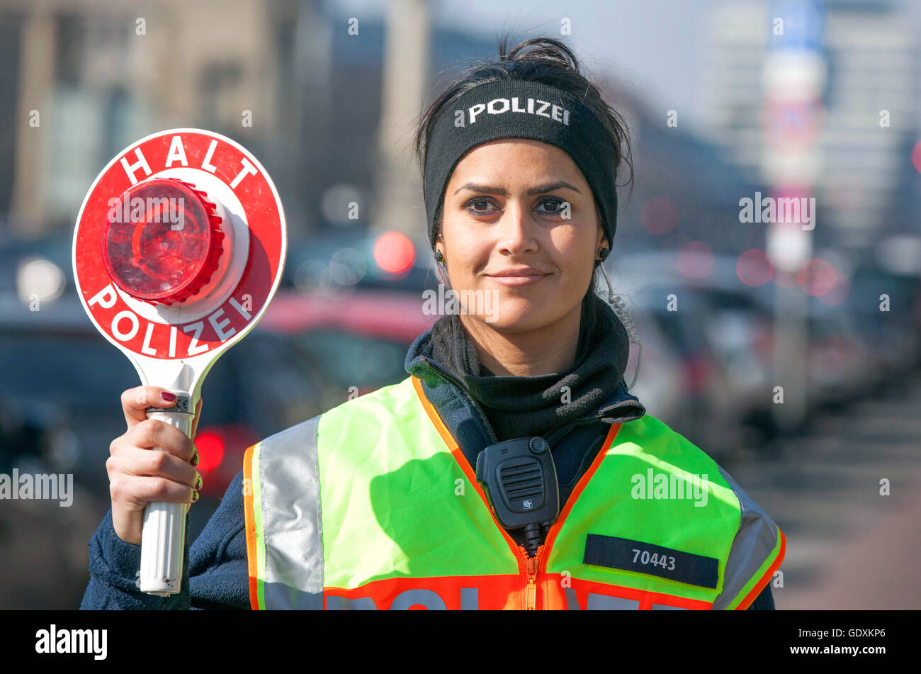 Policewoman with signalling disc during a road check Stock Photo - Alamy