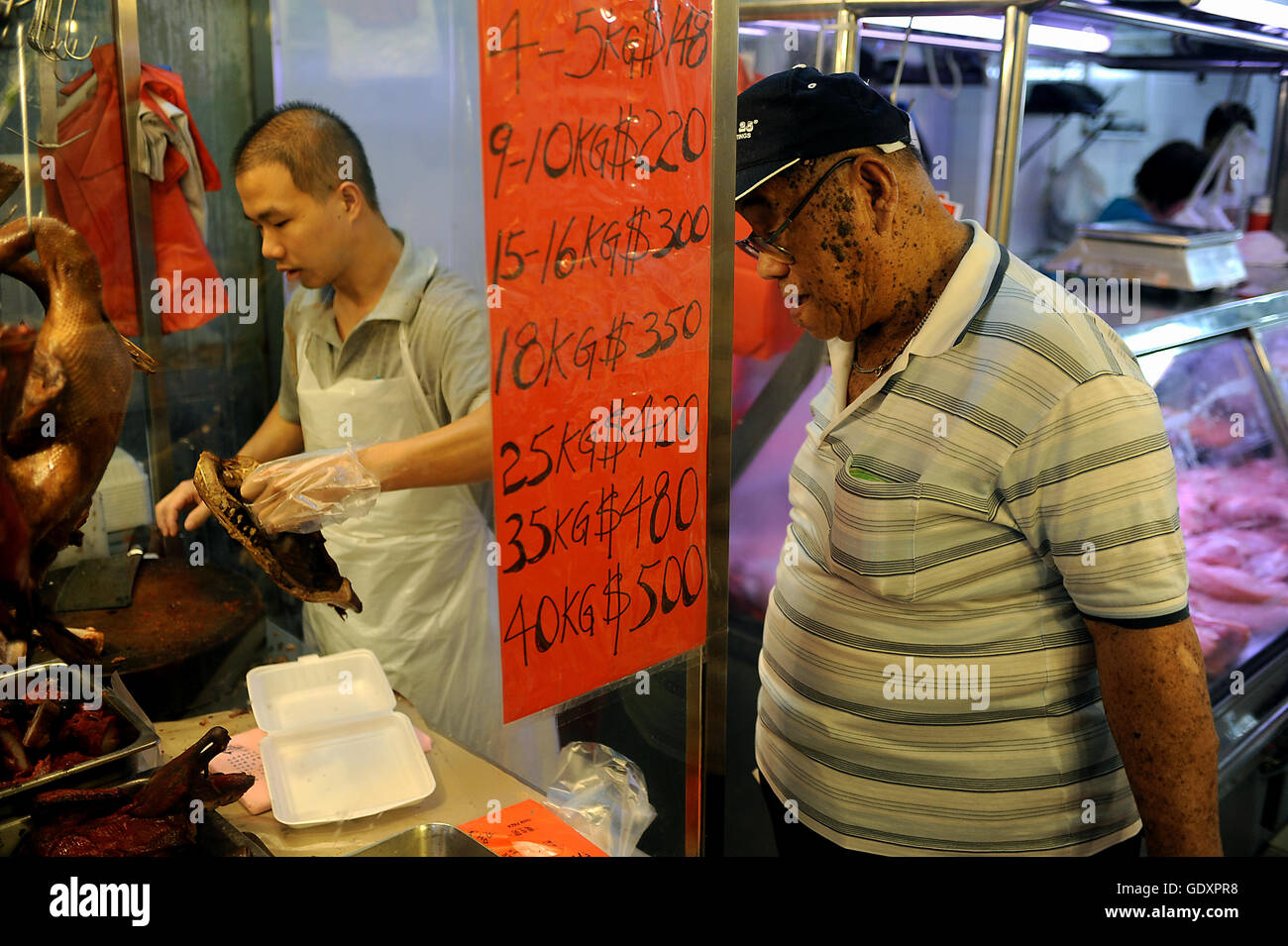 SINGAPORE. 2015. Poultry butcher Stock Photo - Alamy