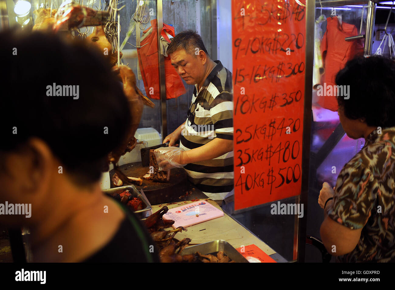 SINGAPORE. 2015. Poultry butcher Stock Photo - Alamy
