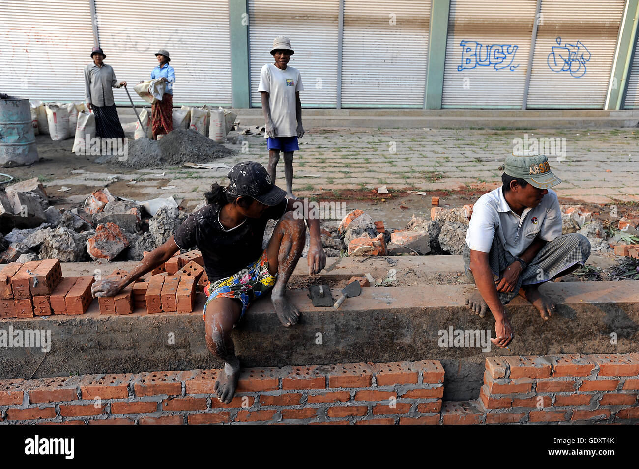 MYANMAR. Yangon. 2014. Road construction workers Stock Photo - Alamy