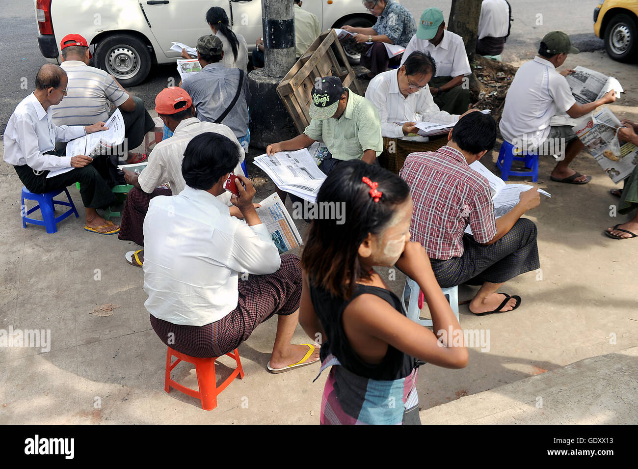 MYANMAR. Yangon. 2015. Newspaper readers Stock Photo - Alamy