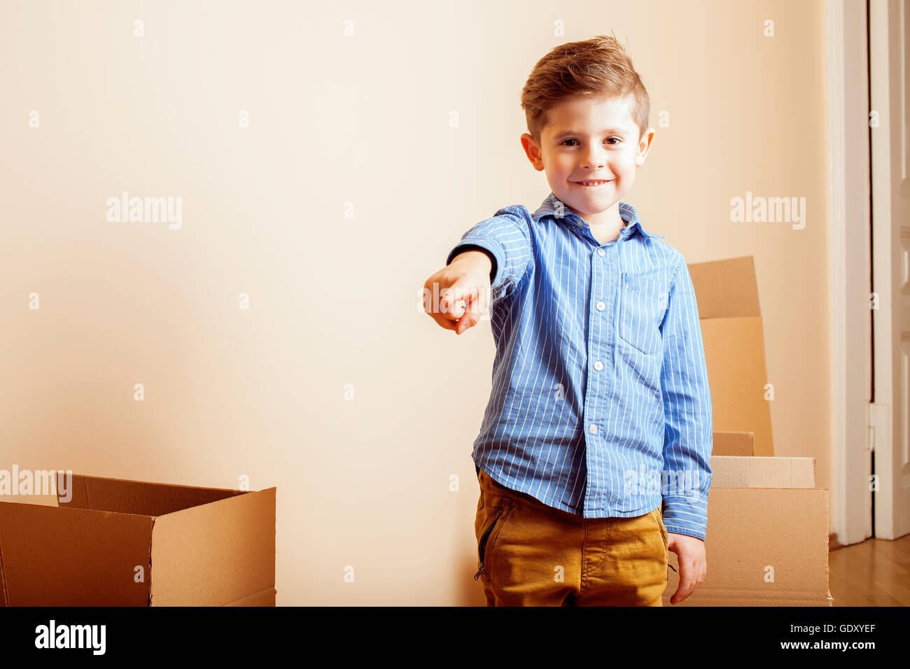 little cute boy in empty room, remoove to new house. home alone emong ...