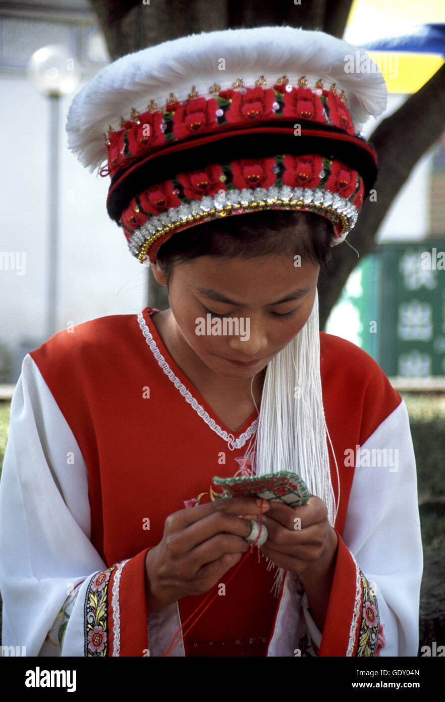 A Sani girl doing embroidery at the Yunnan Nationalities Village near ...
