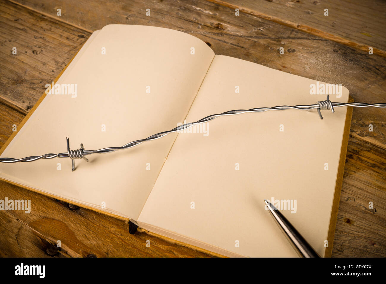 Notebook and pen with barbed wire, a press censorship concept Stock ...