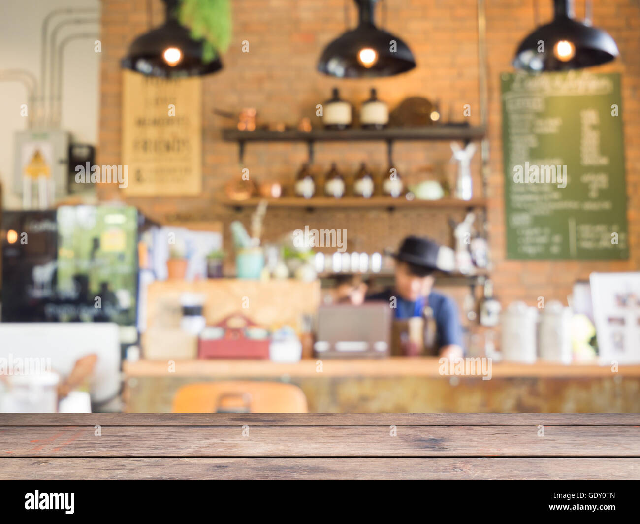 Wooden table with blurred coffee shop background Stock Photo - Alamy