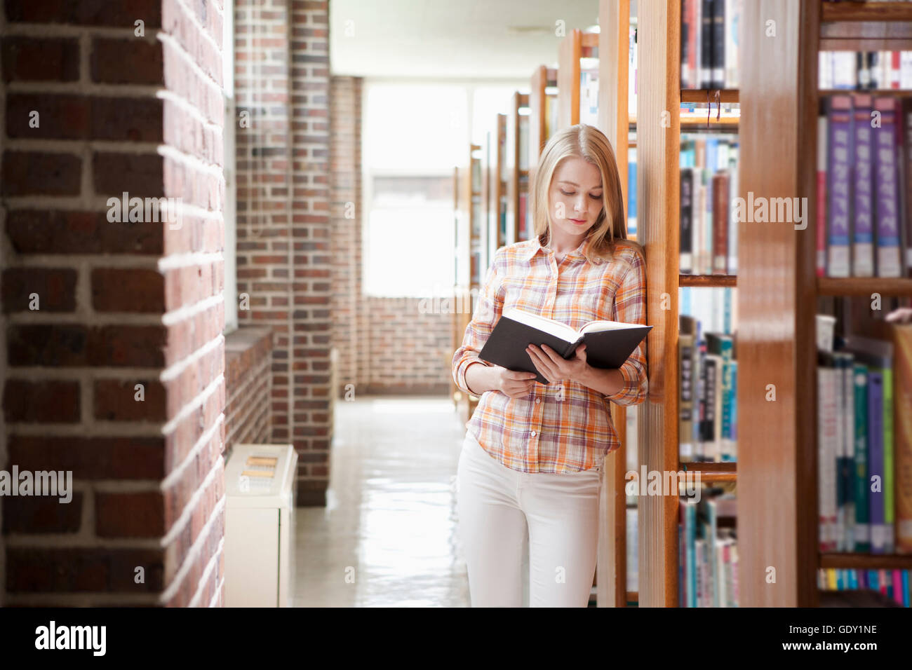 Young woman book standing hi-res stock photography and images - Alamy